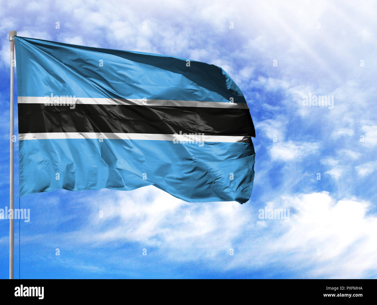 National flag of Botswana on a flagpole in front of blue sky Stock ...