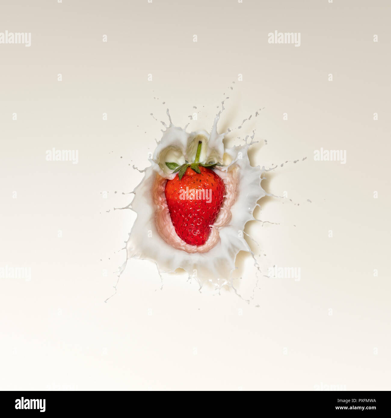 Strawberry falling into milk hi-res stock photography and images - Alamy