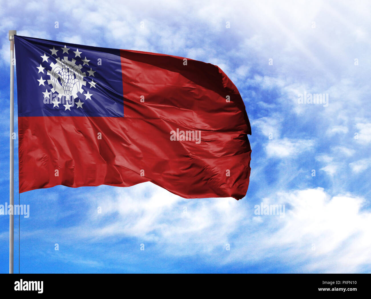 National flag of Myanmar-Burma on a flagpole in front of blue sky Stock ...
