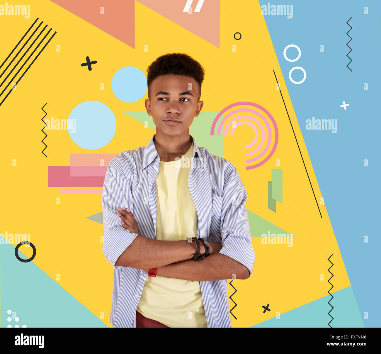 Calm boy standing with his arms crossed and thinking Stock Photo - Alamy