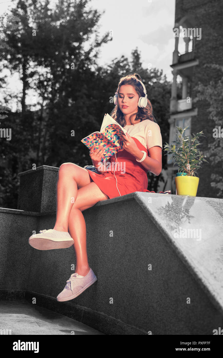 Diligent student feeling busy looking through her notebook getting ...