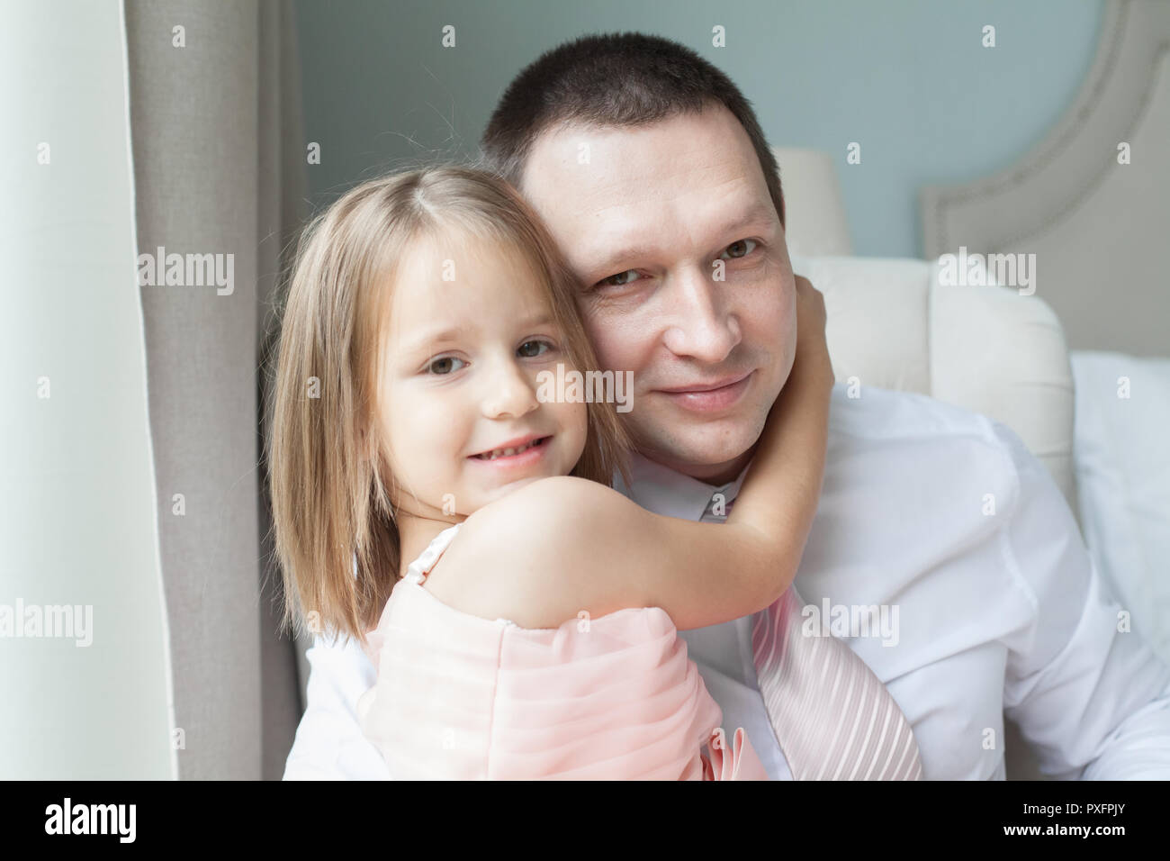 Father and daughter cuddling at home Stock Photo - Alamy
