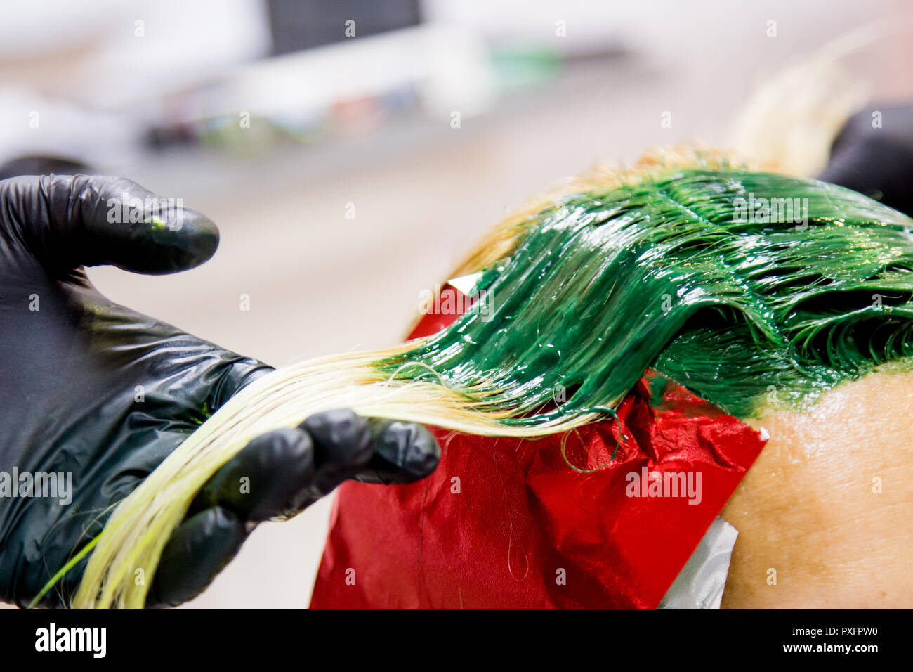 Professional hairdresser dyeing hair. Multicolor Fluorescent staining ...