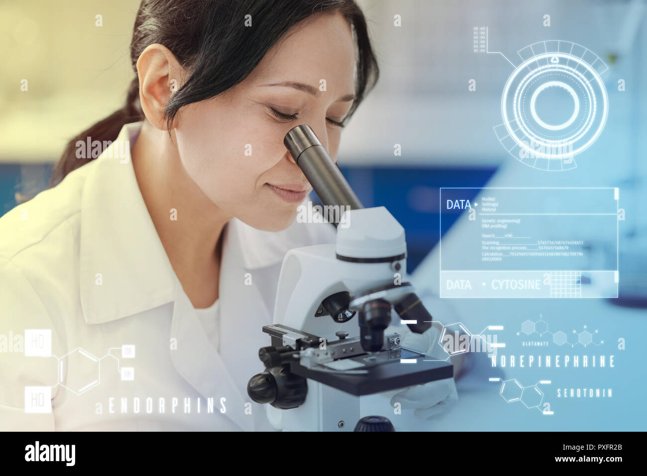 Peaceful woman smiling while working with a modern microscope Stock ...