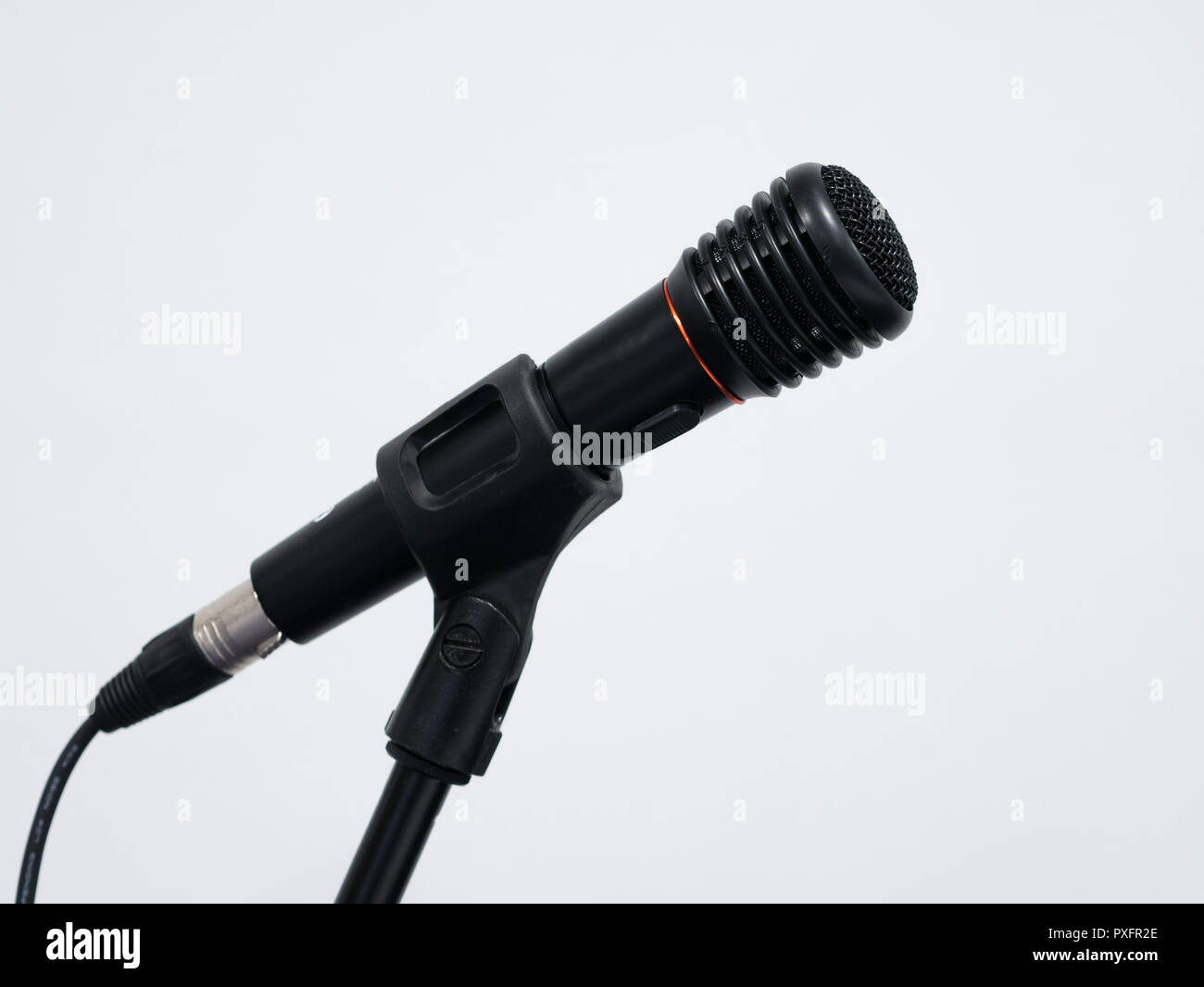 Black wired mic on stand at white background Stock Photo - Alamy