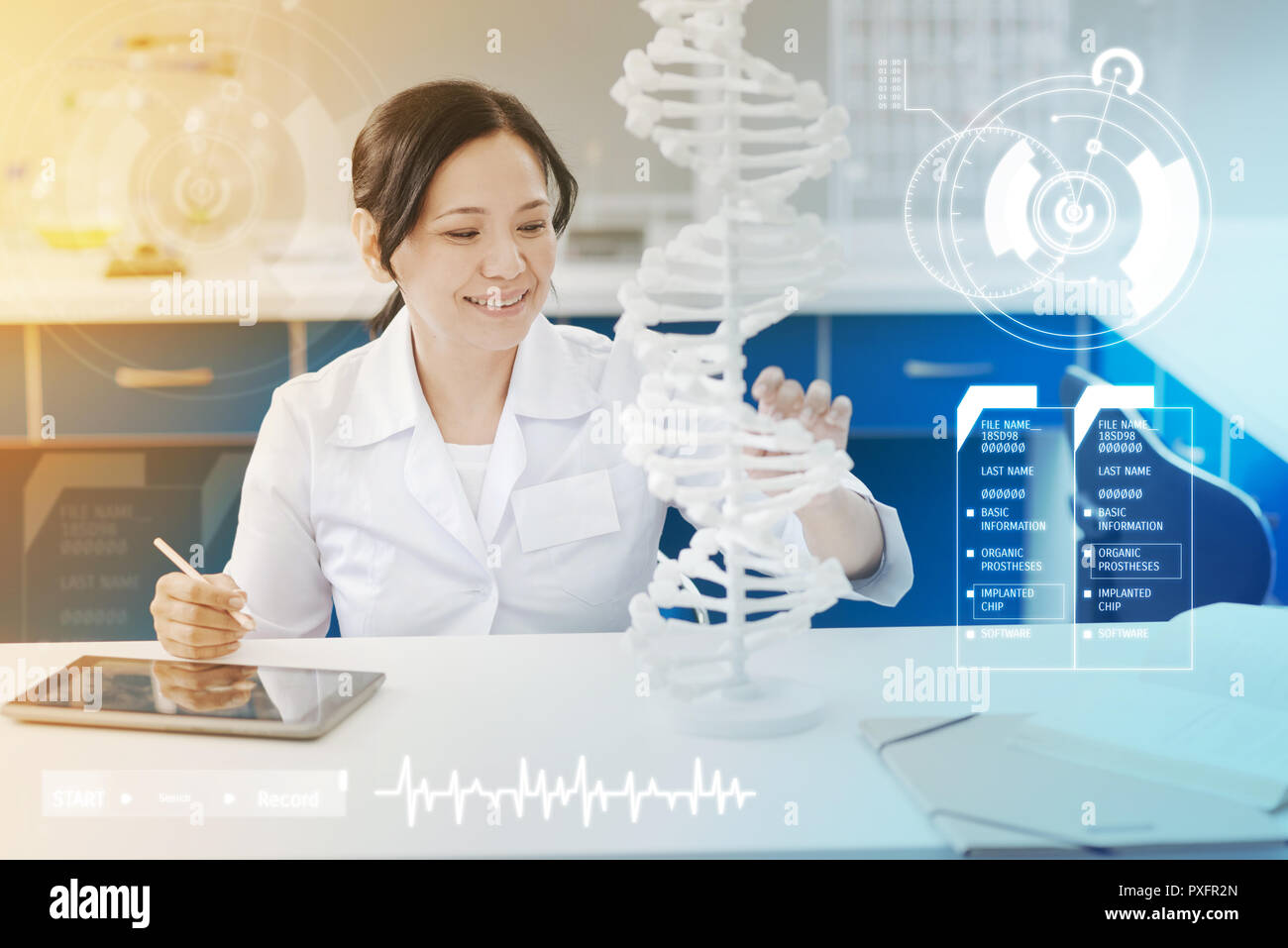 Happy biologist touching the DNA model and smiling Stock Photo - Alamy