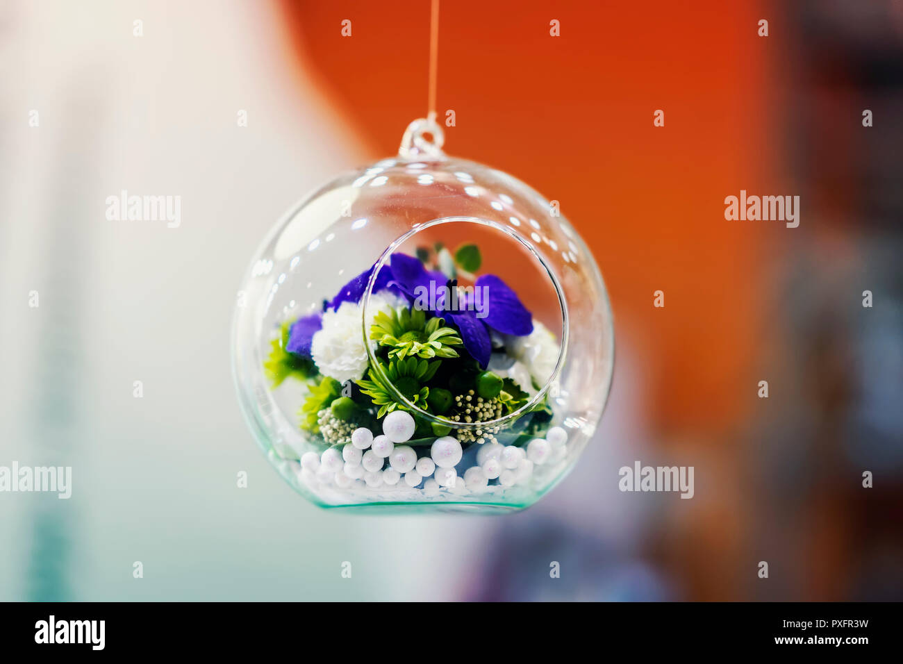 Hanging glass ball, bubble with colorful flowers inside, bright white ...