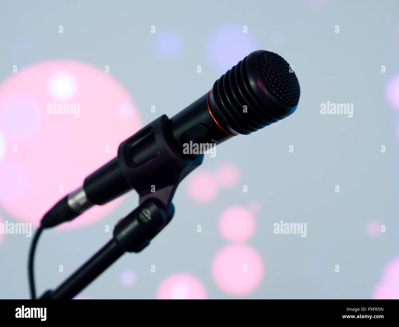 Wired black microphone on stand at club stage indoors Stock Photo - Alamy