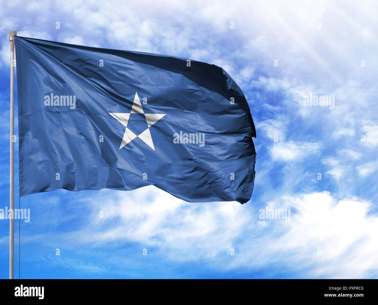 National flag of Somalia on a flagpole in front of blue sky Stock Photo ...