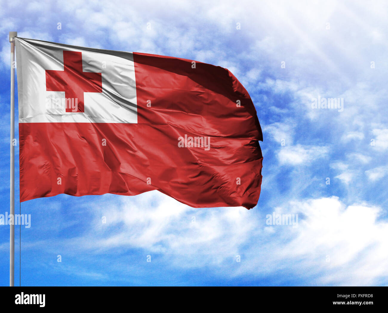 National flag of Tonga on a flagpole in front of blue sky Stock Photo ...