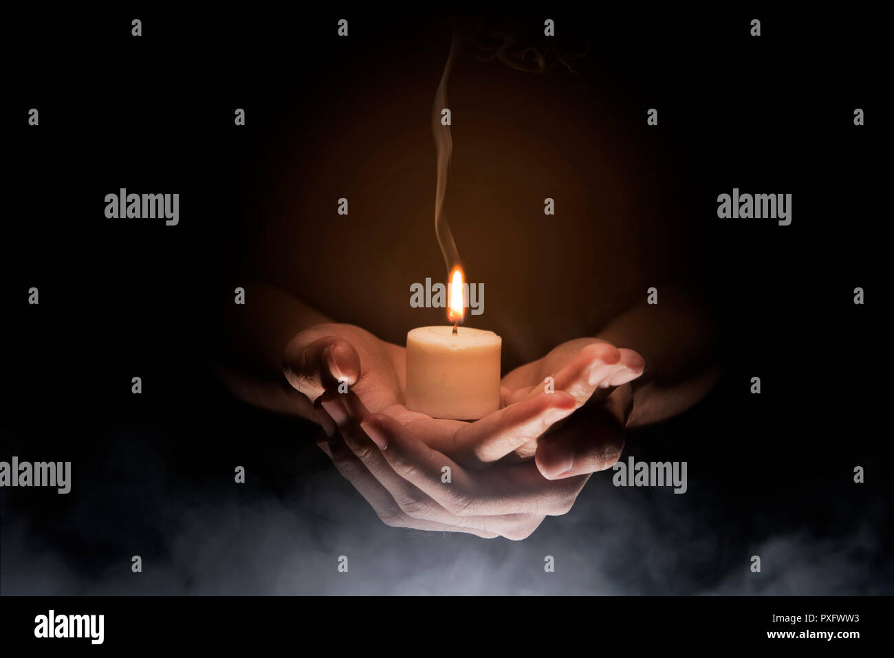 Hands holding candle over dark background. Christian Pray Stock Photo ...