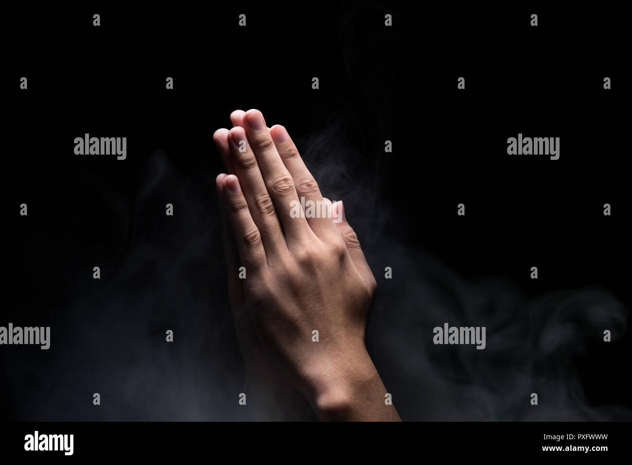 Hands with praying gesture over dark background. Christian Pray Stock ...