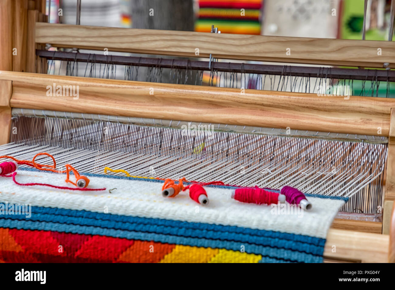 A traditional colorful vintage weaving loom and thread of yarn Stock ...