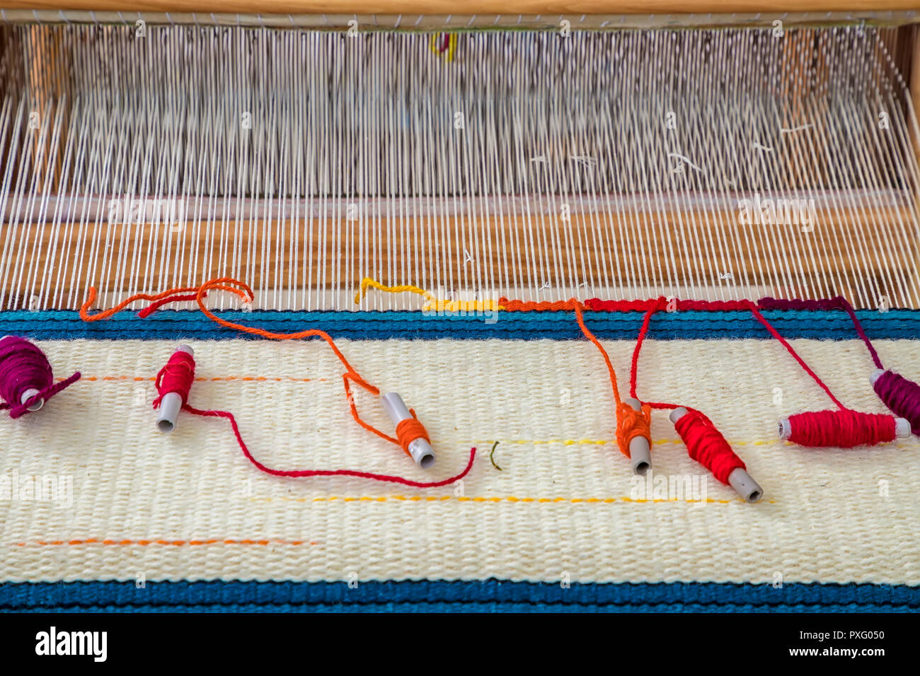 A traditional colorful vintage weaving loom and thread of yarn Stock ...