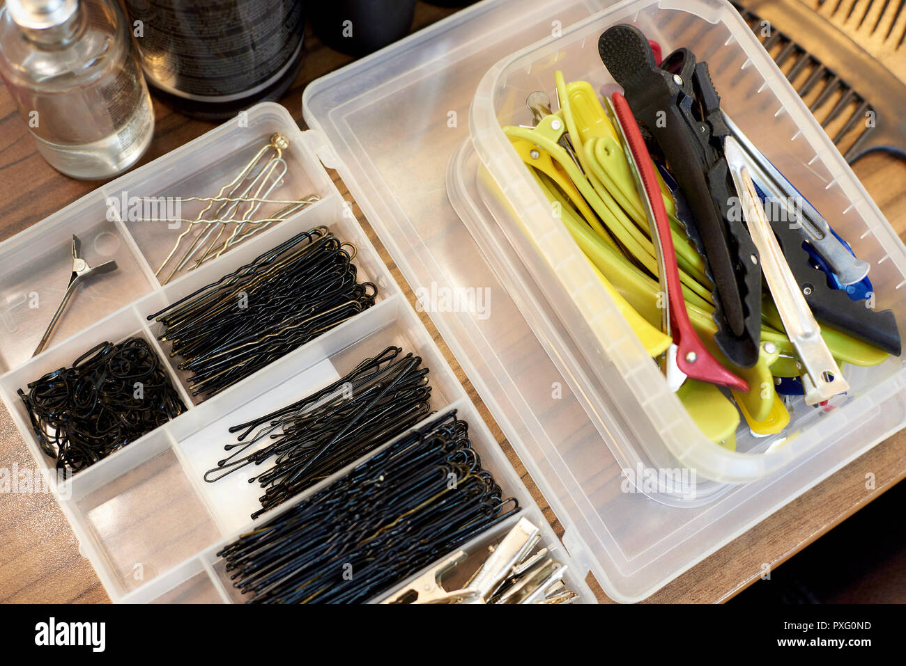 Box with various scrunchy, hair pins on the table stylist with ...