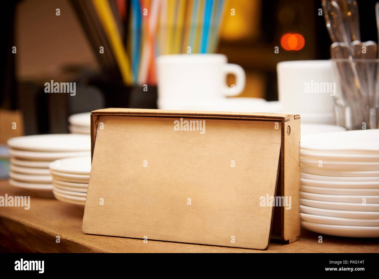 Wooden box on the table with stacks of plates and cups Stock Photo - Alamy