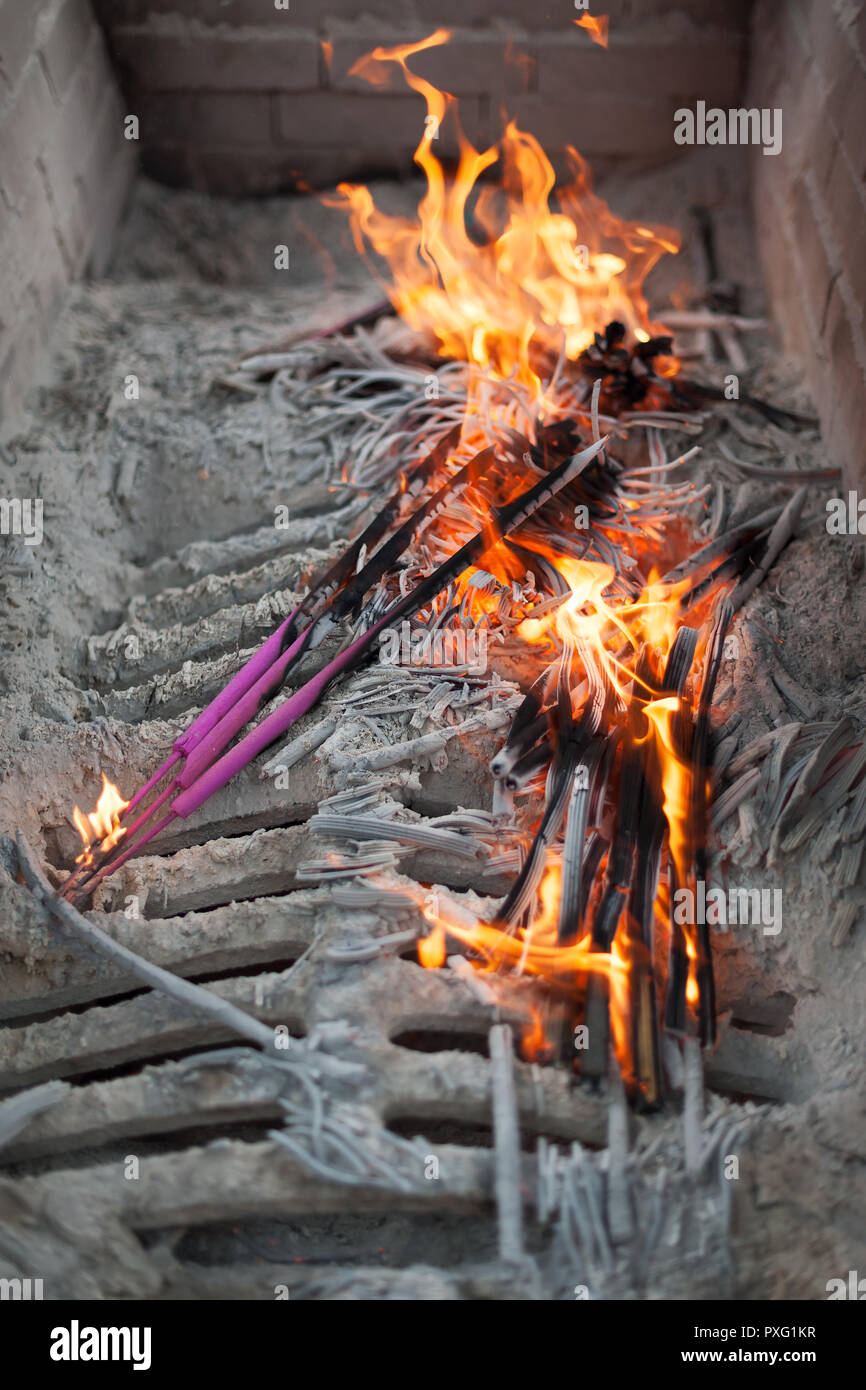Burning incense sticks with flames in a chinese buddhist temple Stock ...