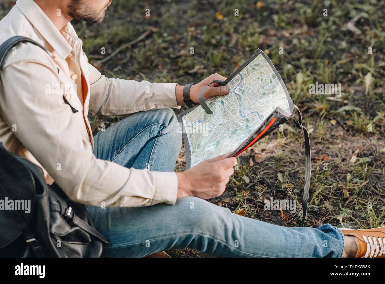 partial view of traveler with map in hands in park Stock Photo - Alamy