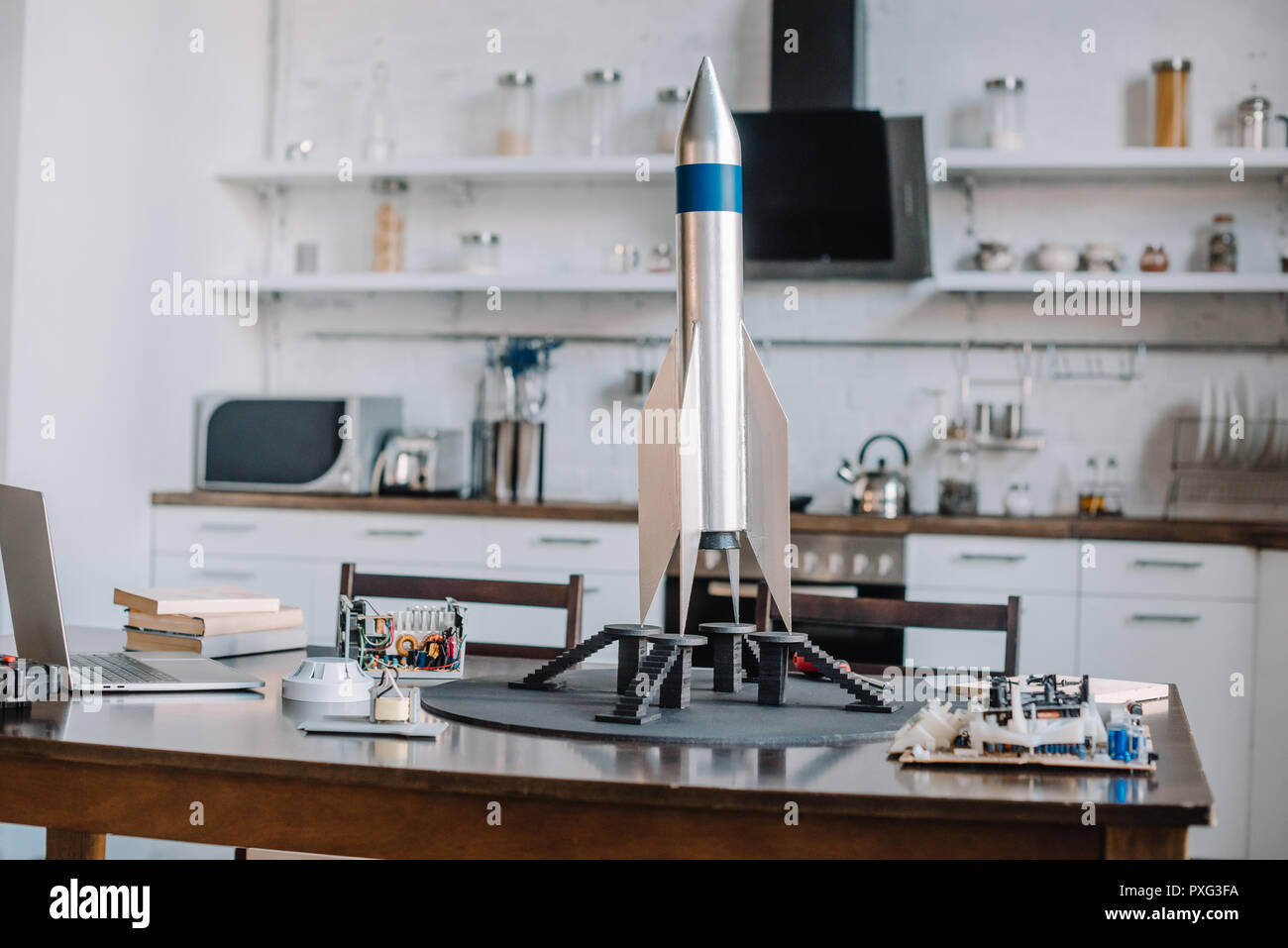 rocket model and tools for engineering on table in kitchen Stock Photo ...