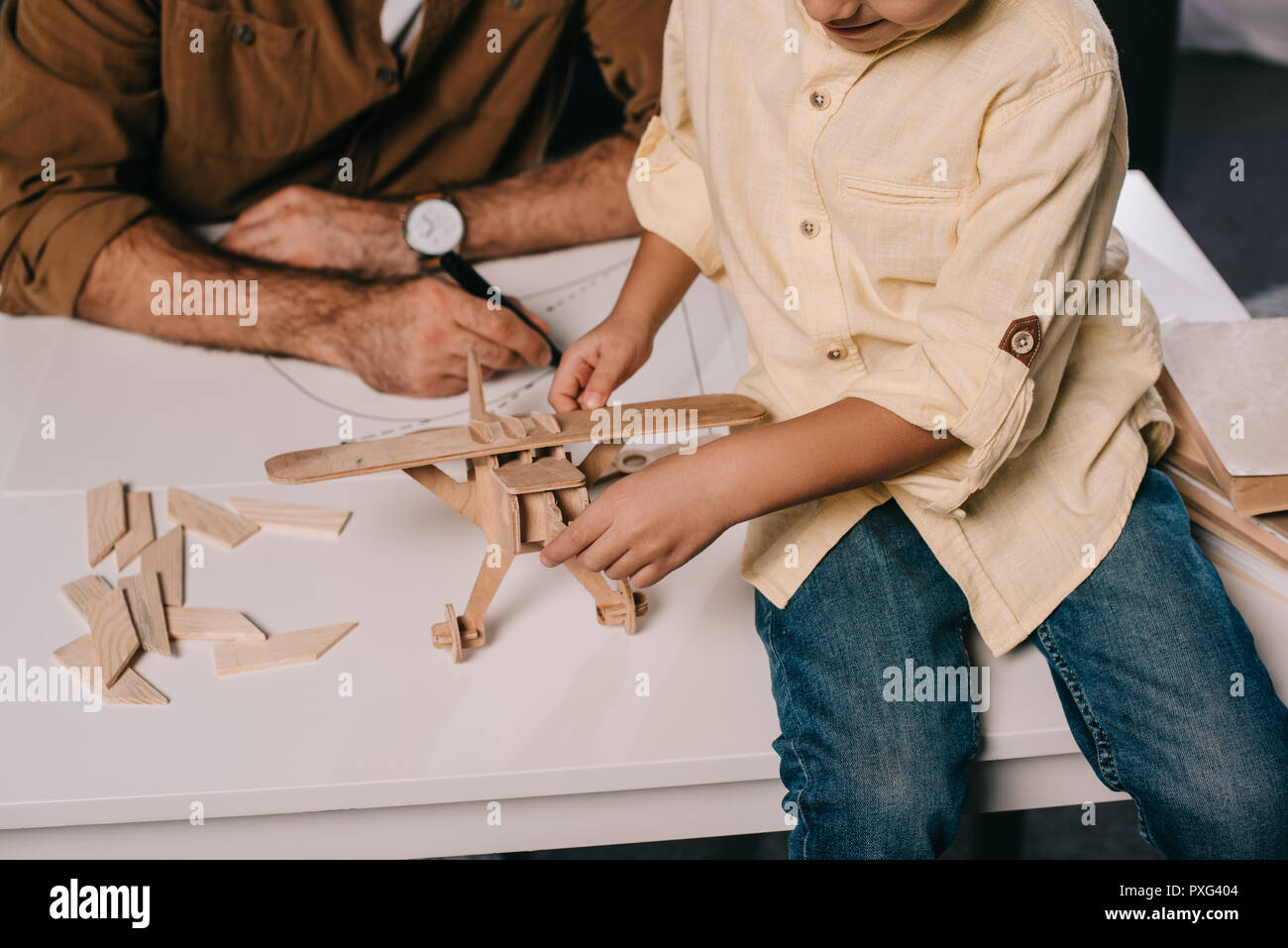 cropped shot of father and little son modeling together at home Stock ...