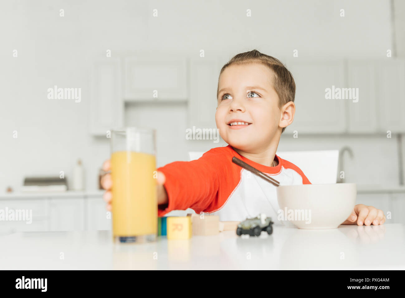 portrait of little boy having breakfast in kitchen at home Stock Photo ...