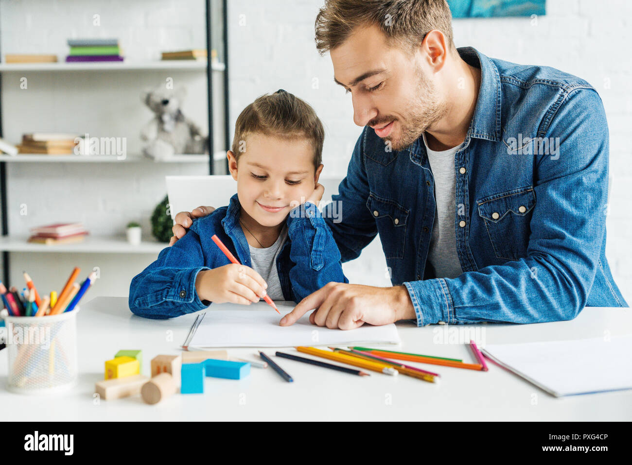 handsome young father drawing with son at home Stock Photo - Alamy