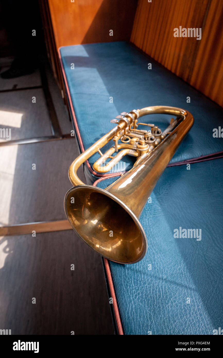 Blowing brass gold wind instrument on the bench Stock Photo - Alamy