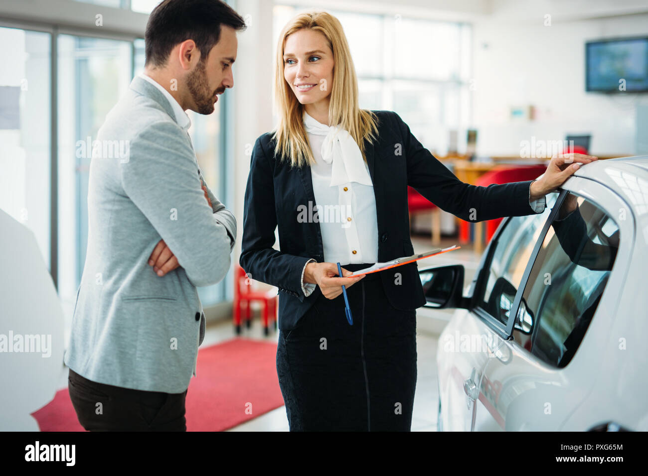 Professional salesperson selling cars at dealership to buyer Stock ...