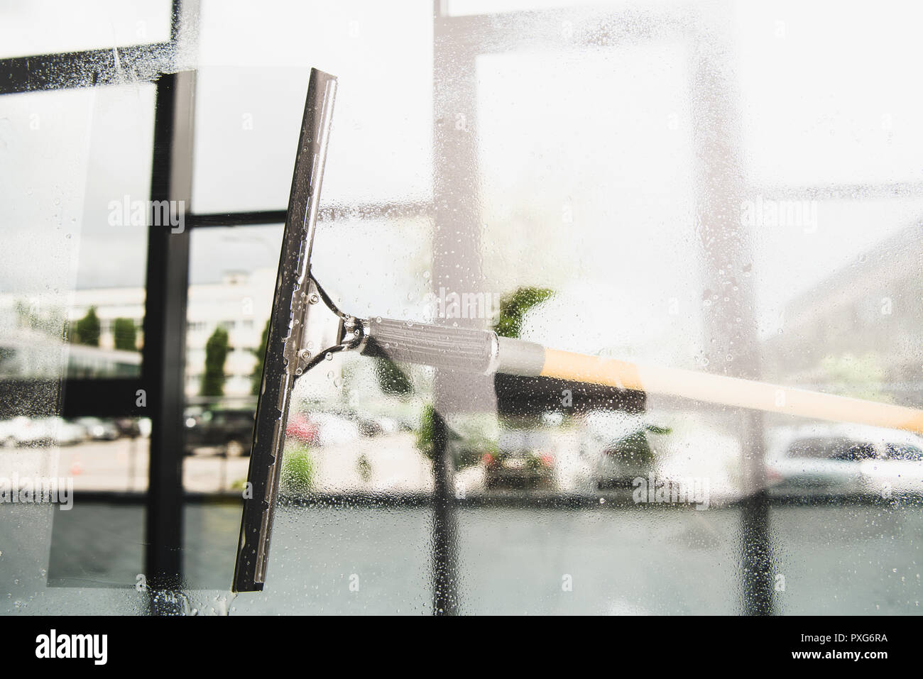 close-up view of cleaning and wiping window with squeegee Stock Photo ...