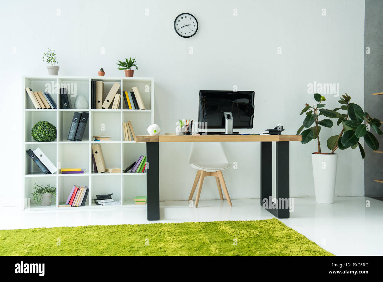 modern office interior with computer monitor on table and books with ...