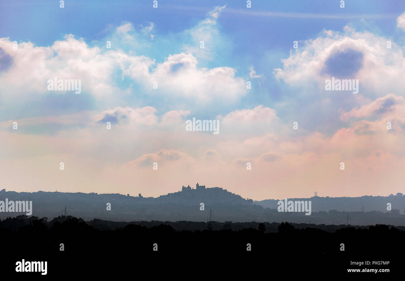 Panoramic shape of the medieval white village of Ostuni at sunset Stock ...