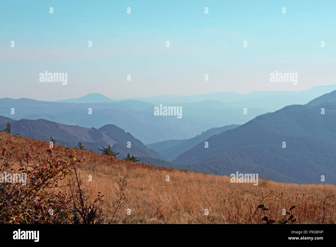 A hazy view of Oregon mountain ranges from the top of Mary's Peak just ...