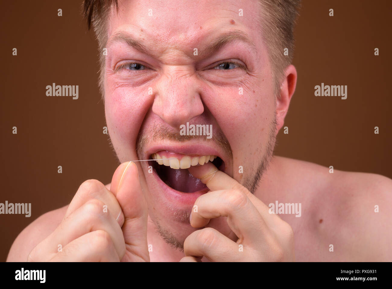 Face of man using dental floss to clean his teeth Stock Photo - Alamy