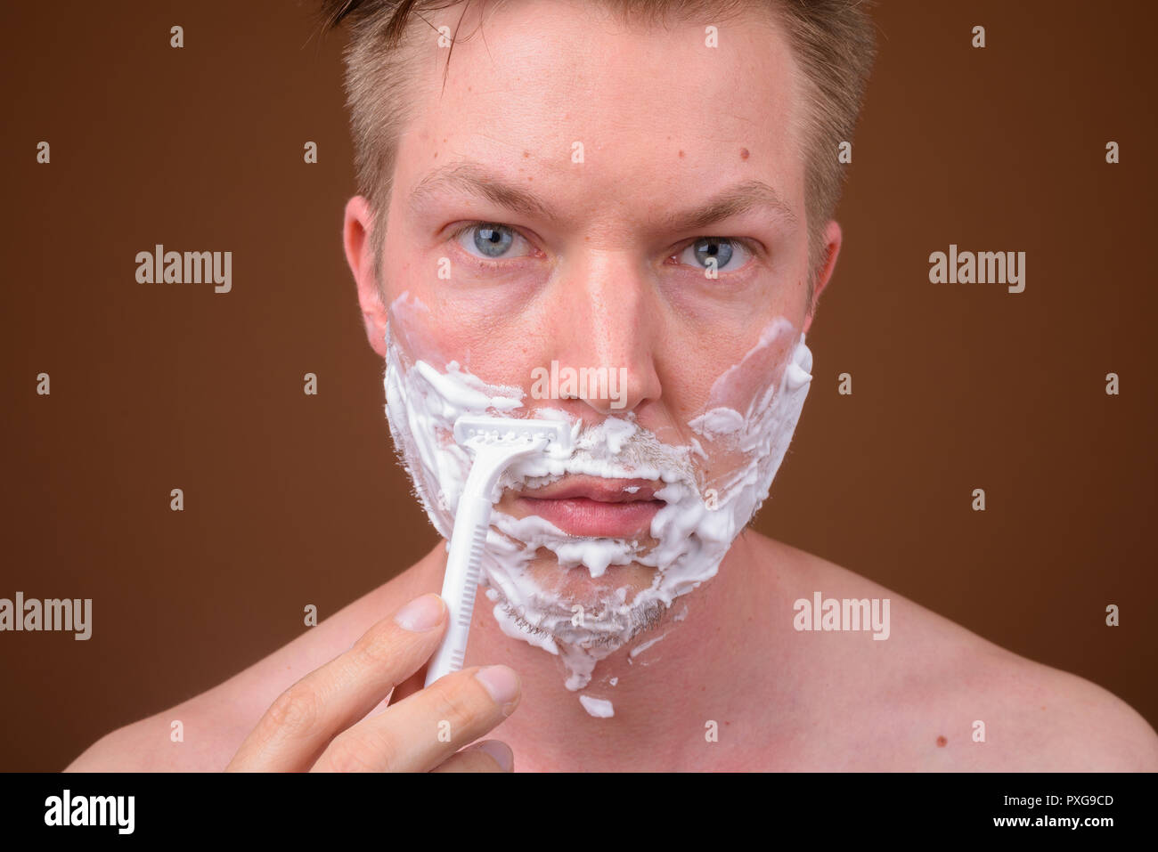 Face of young man shaving his face Stock Photo - Alamy