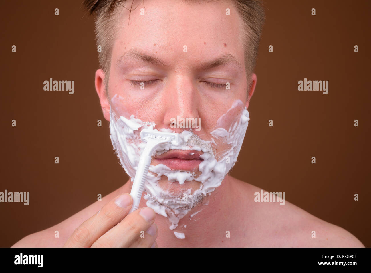 Face of young man shaving his face Stock Photo - Alamy