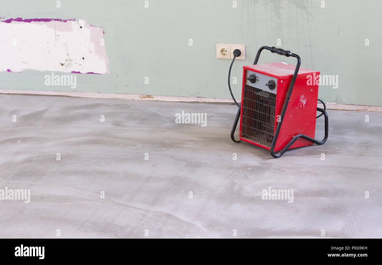 Compact red heater, drying the floor before installing the PVC floor ...