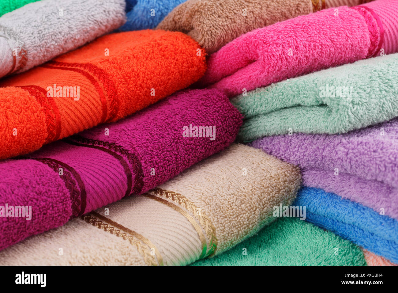 Colorful folded towels stack closeup picture Stock Photo - Alamy