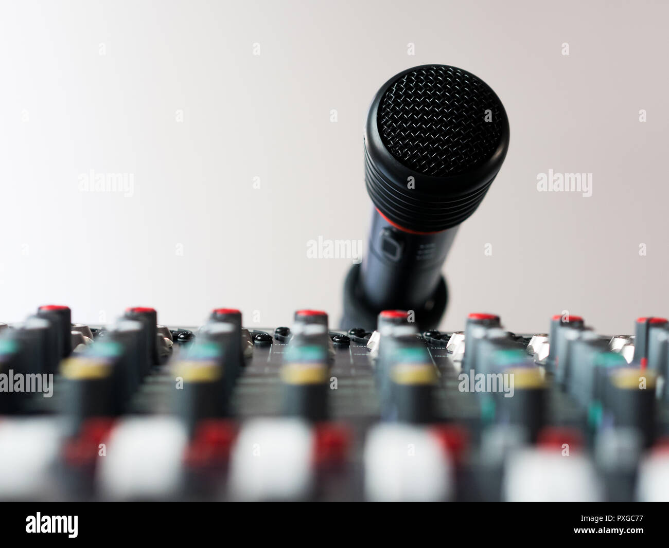 Black microphone over audio mixer in music recording studio close up ...