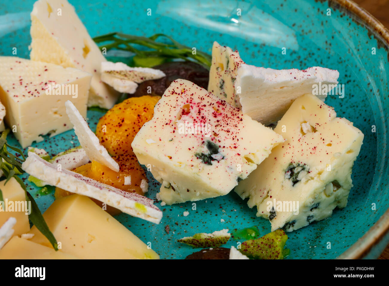 Cheeses plate mix served estragon Stock Photo - Alamy