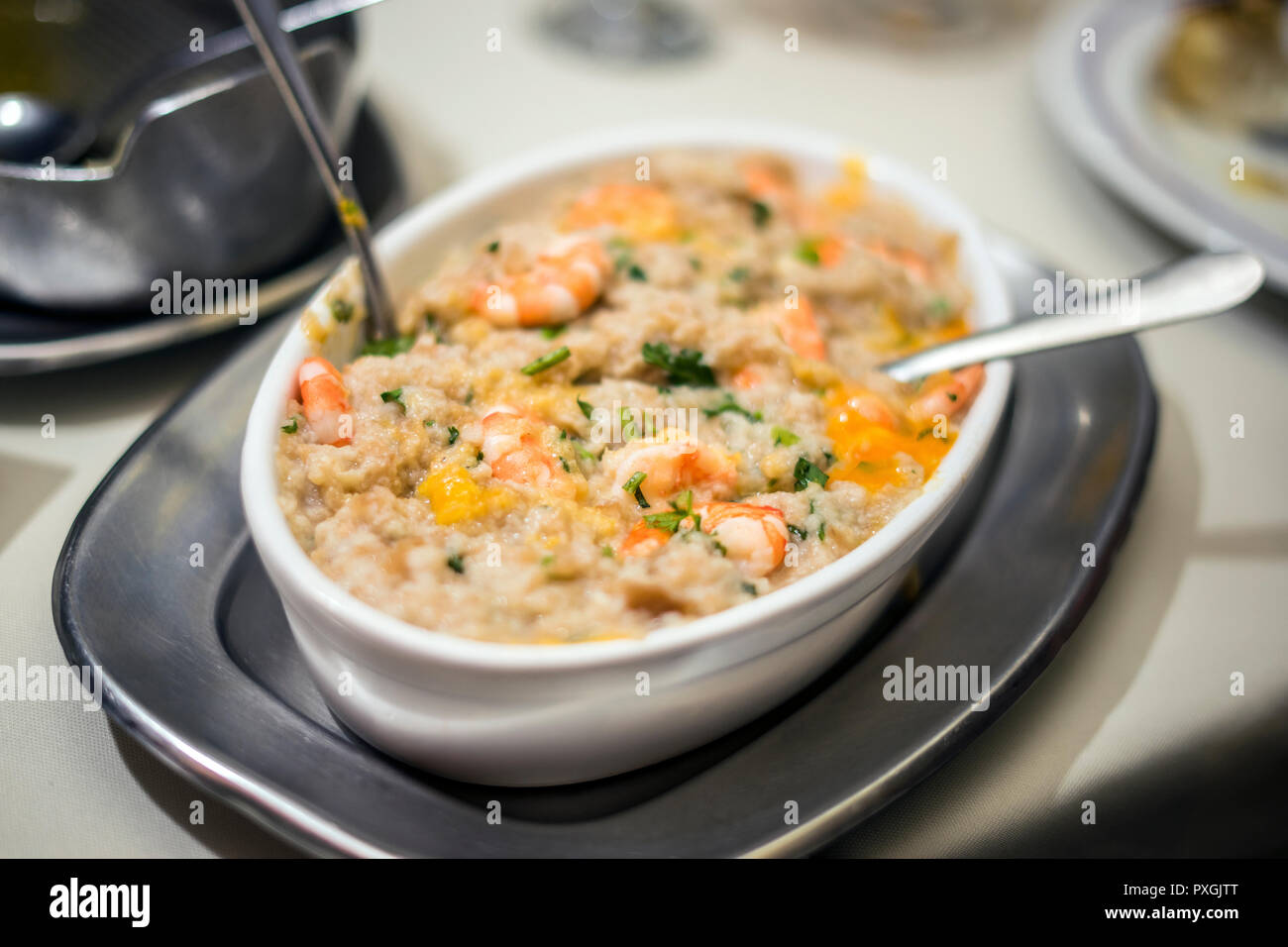 Traditional portuguese seafood dish with rice, shrimps and fresh egg ...