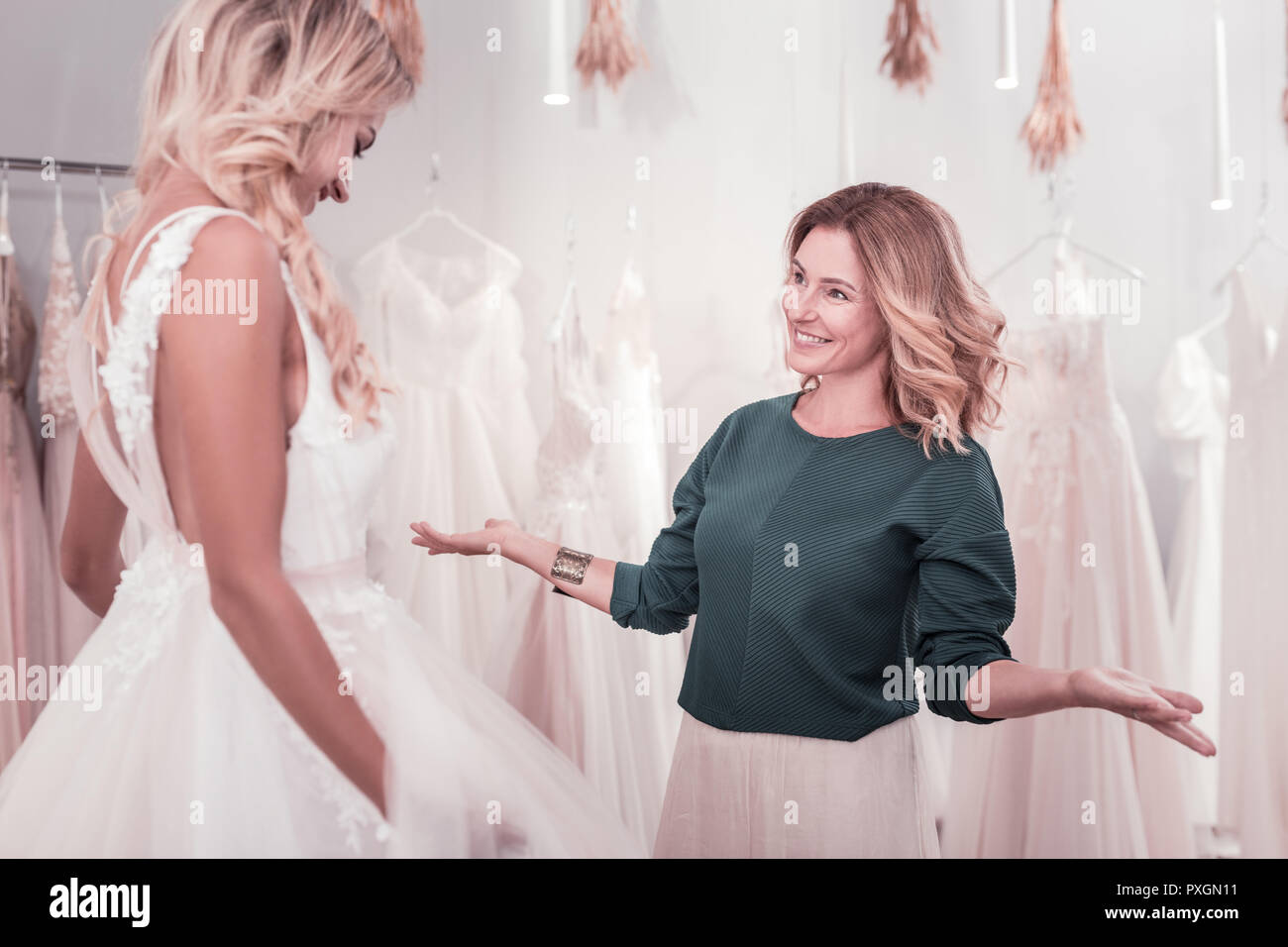 Cheerful nice blonde woman helping her daughter Stock Photo - Alamy