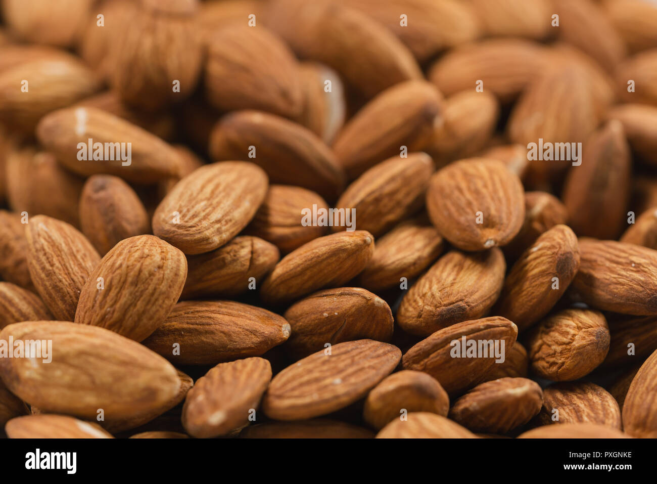 roasted almonds background Stock Photo - Alamy