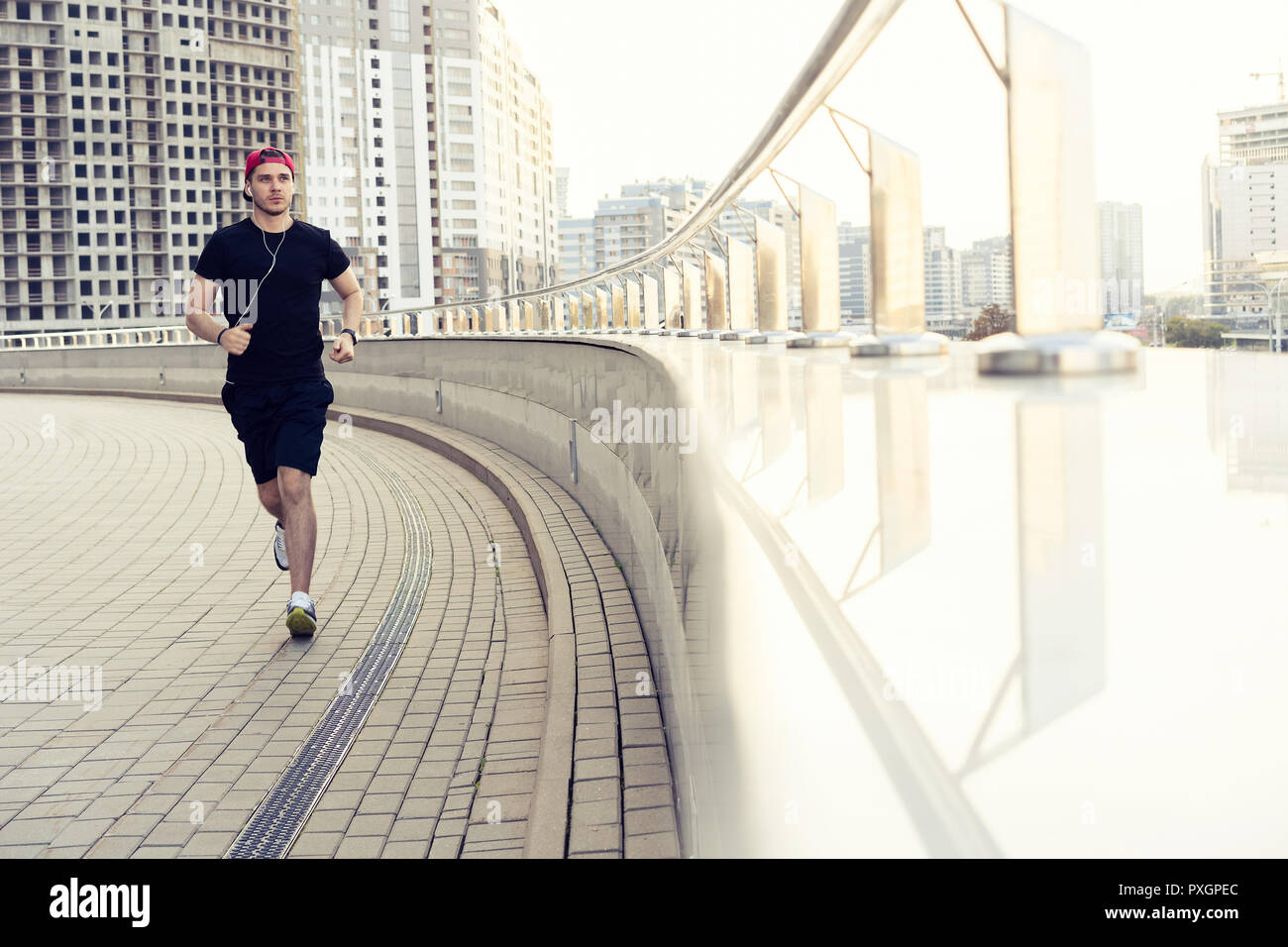 Fit athlete running outdoors to stay healthy. Sporty Young Man Running ...