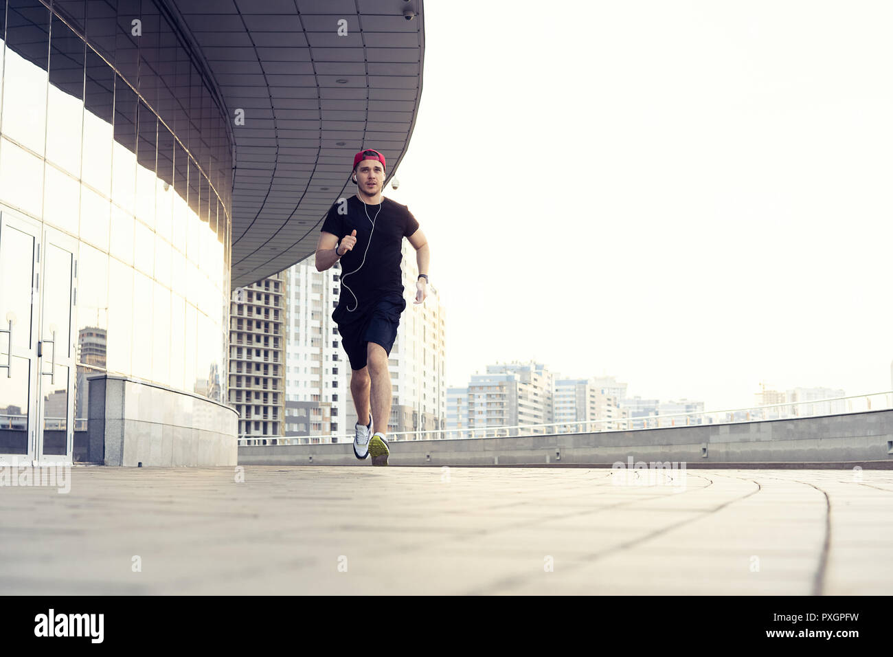 Fit athlete running outdoors to stay healthy. Sporty Young Man Running ...
