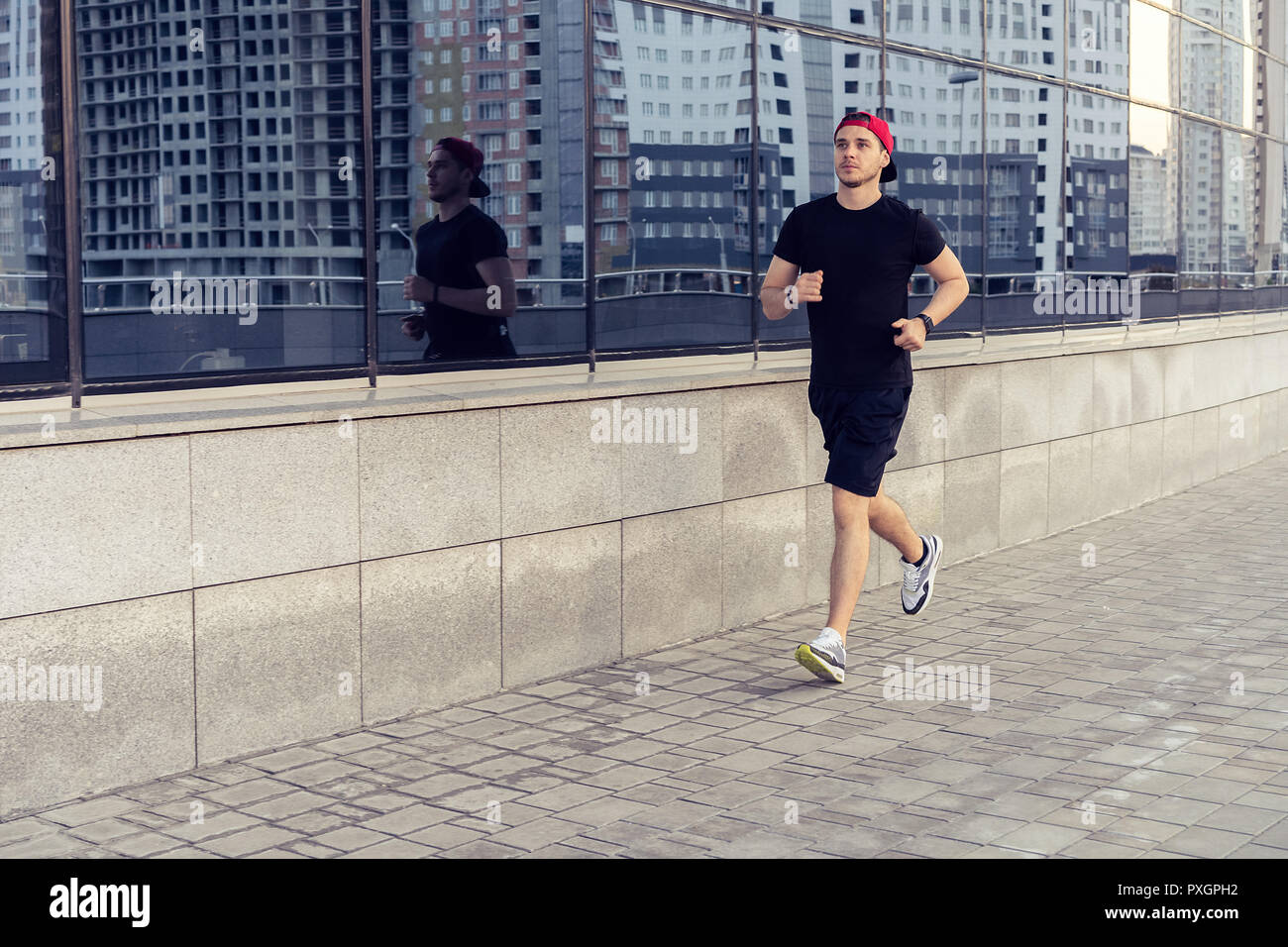 Fit athlete running outdoors to stay healthy. Sporty Young Man Running ...