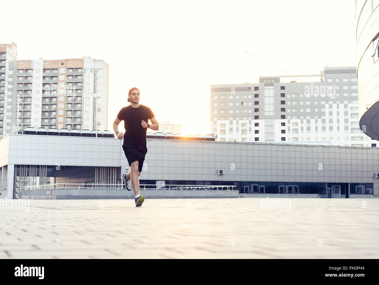 Fit athlete running outdoors to stay healthy. Sporty Young Man Running ...