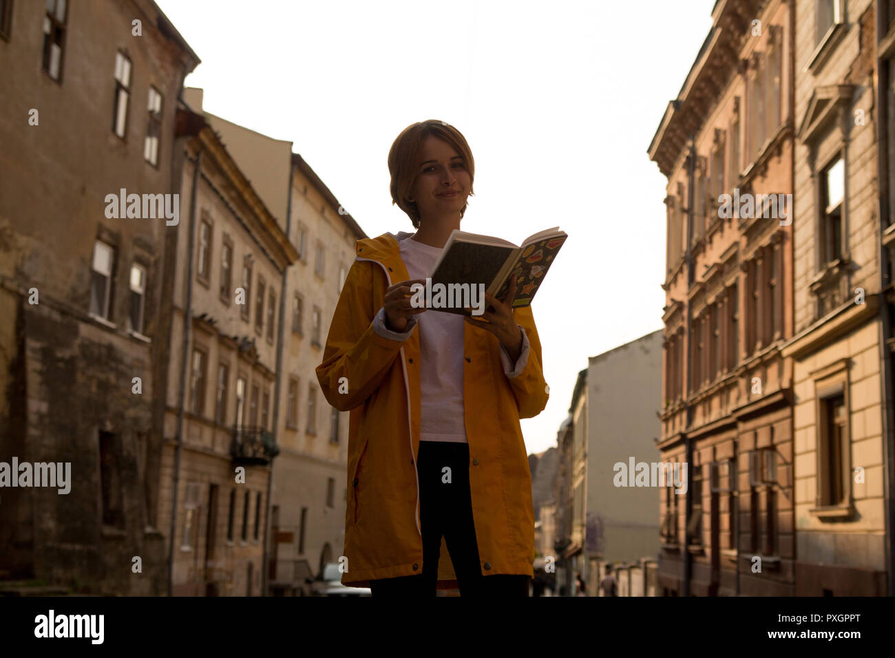 Romantic beautiful girl reading poems while walking Stock Photo - Alamy