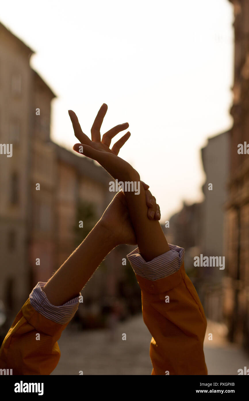 female hands raised while walking Stock Photo - Alamy