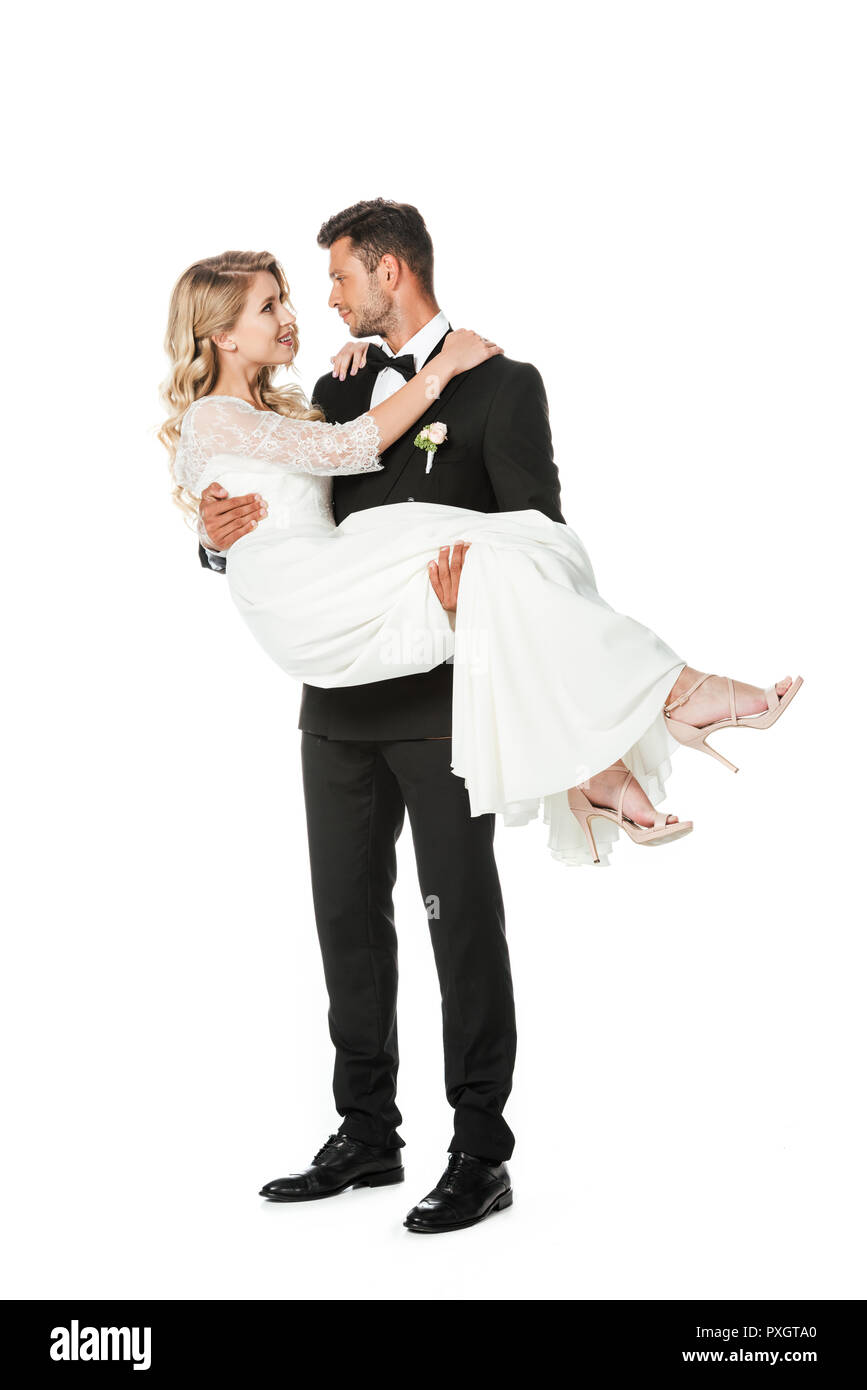 smiling young groom carrying his bride isolated on white Stock Photo ...