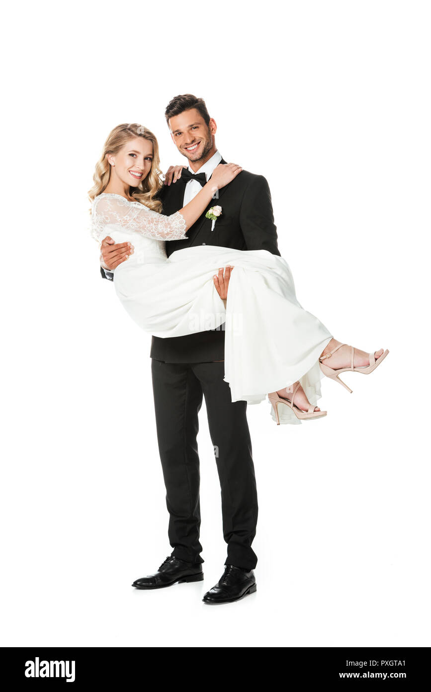 Handsome groom carrying bride hi-res stock photography and images - Alamy